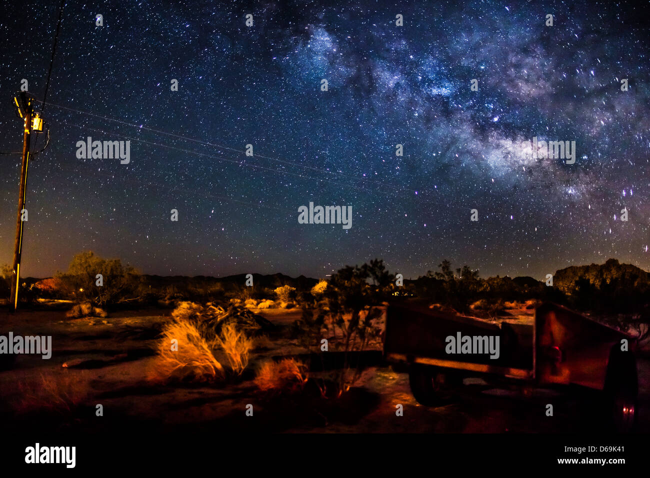 Illuminated night sky over rural landscape Stock Photo - Alamy
