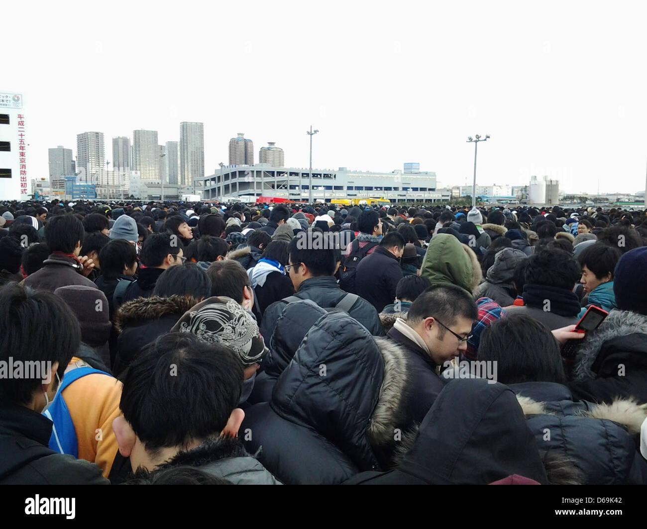 The photo captures a moment at Comiket 83, an event known for its large ...