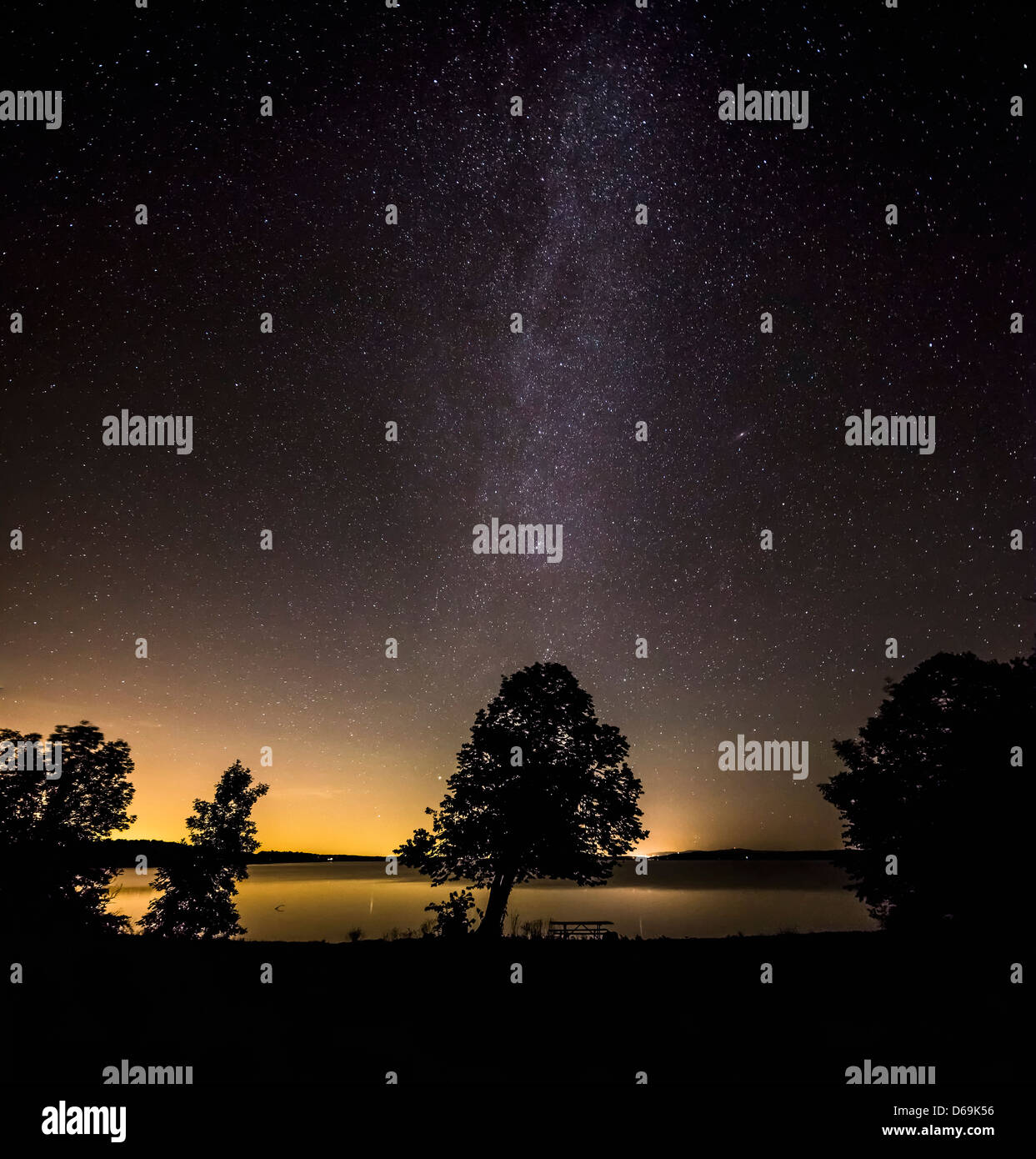 Illuminated night sky over rural landscape Stock Photo - Alamy