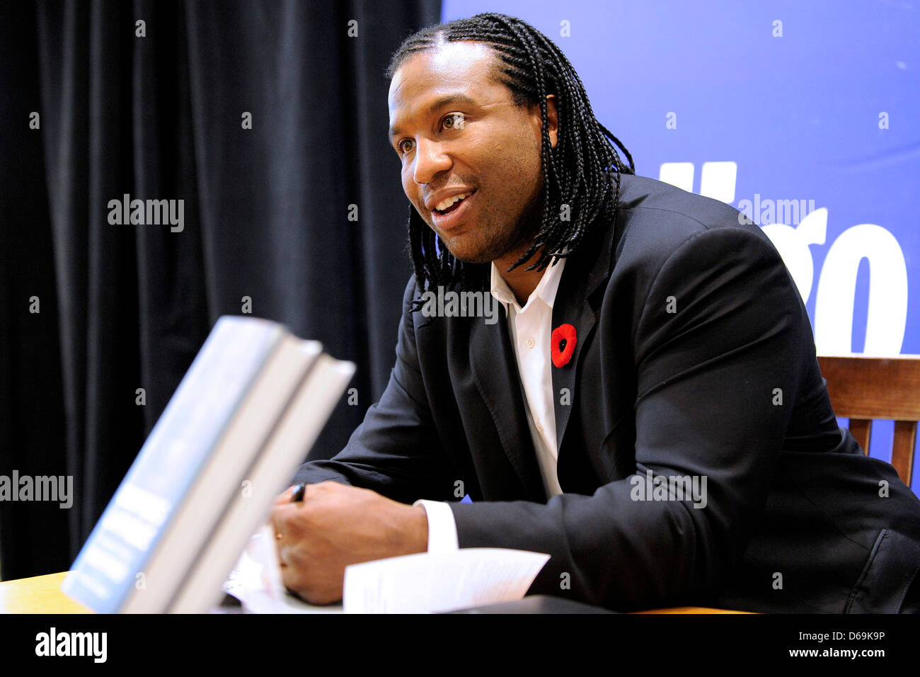 Former NHL player, Georges Laraque, signs his latest book 'The Story of ...