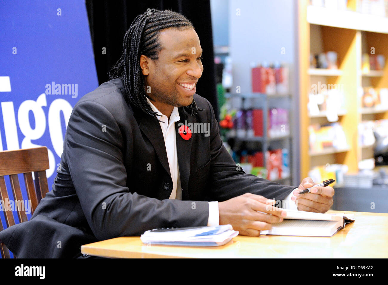 Former NHL player, Georges Laraque, signs his latest book 'The Story of ...