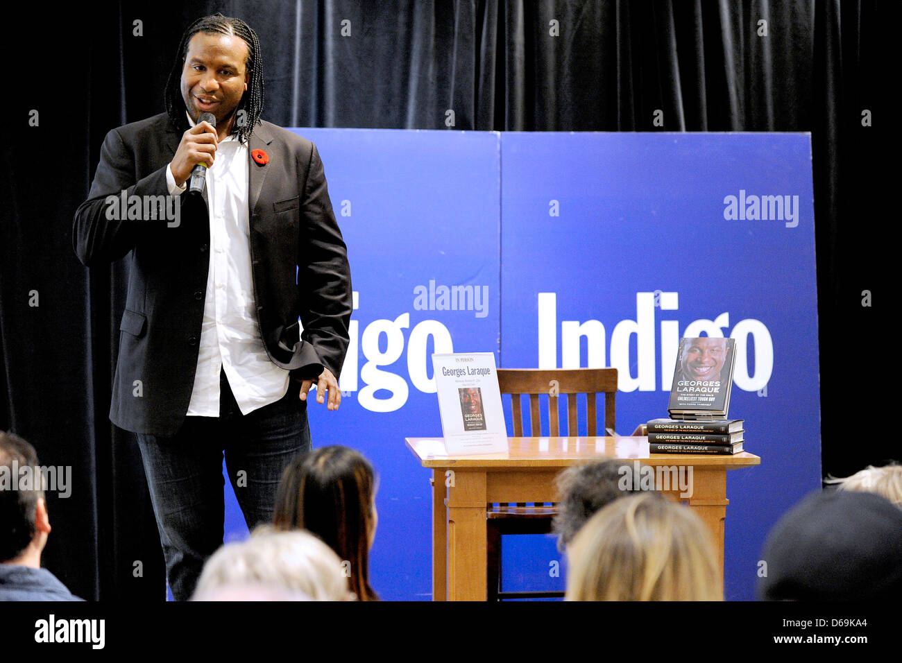 Former NHL player, Georges Laraque, signs his latest book 'The Story of ...