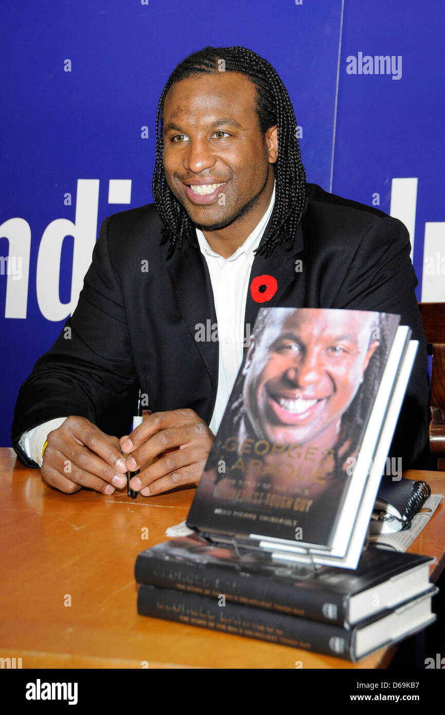 Former NHL player, Georges Laraque, signs his latest book 'The Story of ...
