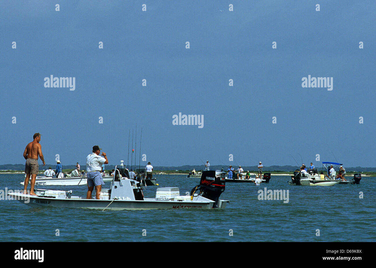 A crowd of people fishing in the bay for speckled trout and redfish ...