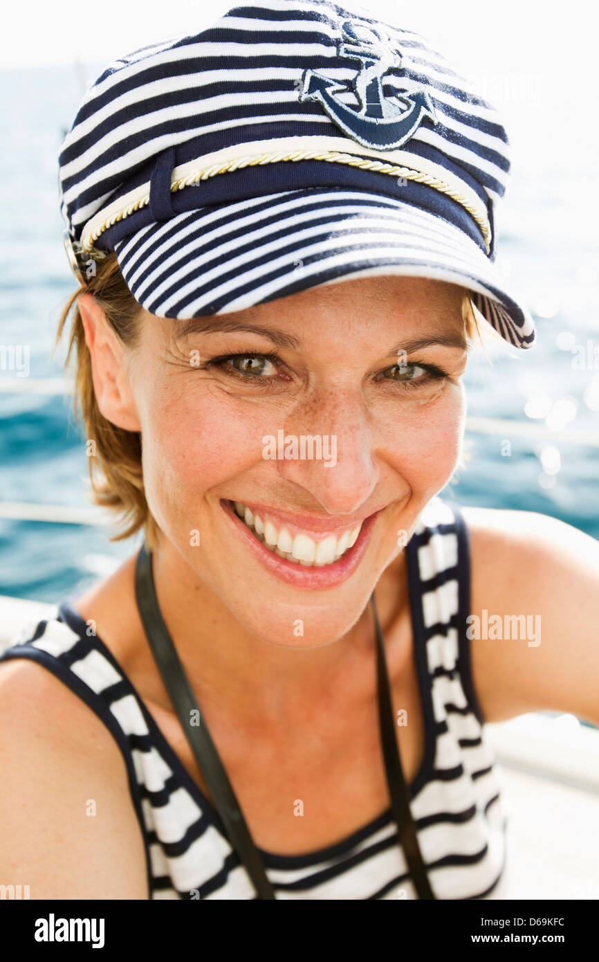 Woman wearing nautical hat and shirt Stock Photo - Alamy