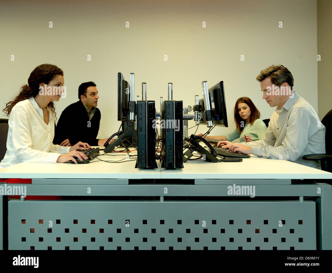 Business people using computers at desk Stock Photo - Alamy
