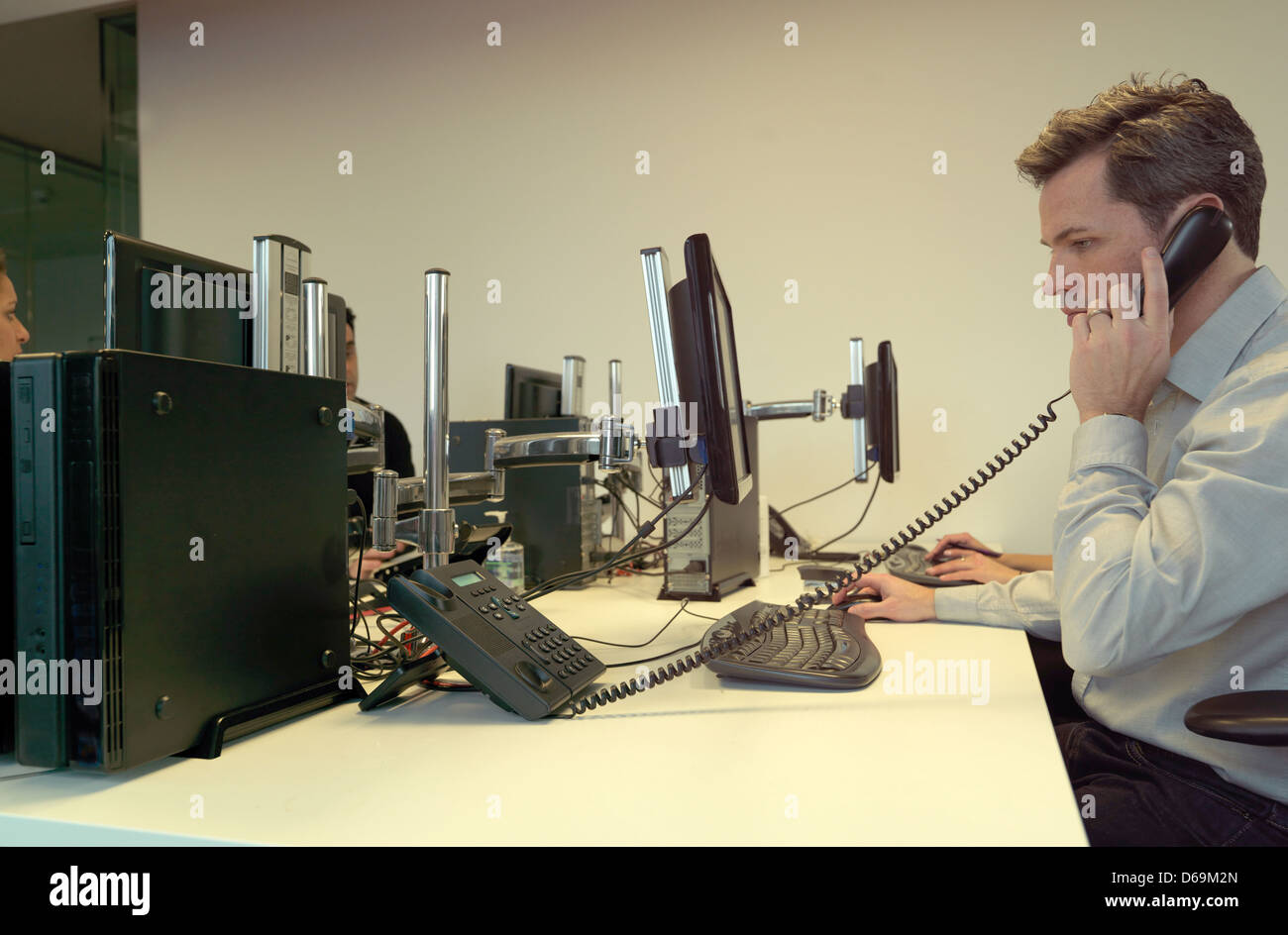 Businessman talking on phone at desk Stock Photo - Alamy