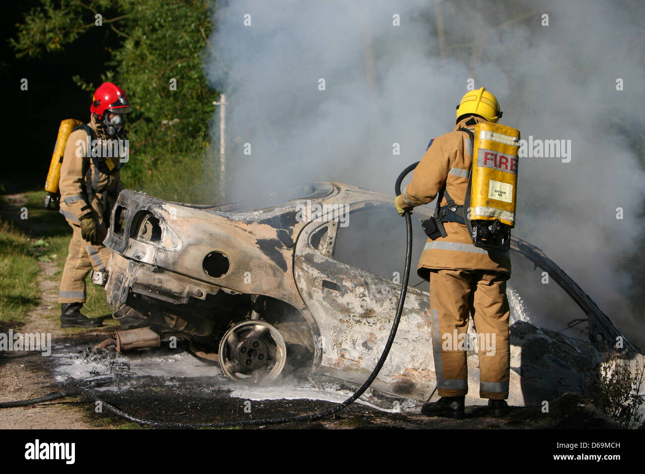 Stolen car on fire being extinguished by fire service, UK Stock Photo ...