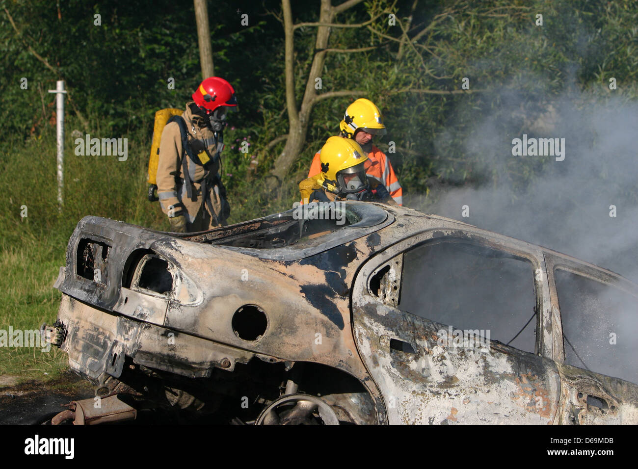 Stolen car on fire being extinguished by fire service, UK Stock Photo ...