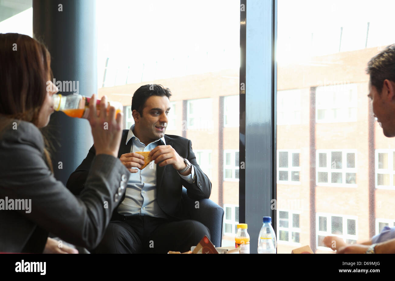 Business people eating in office Stock Photo - Alamy