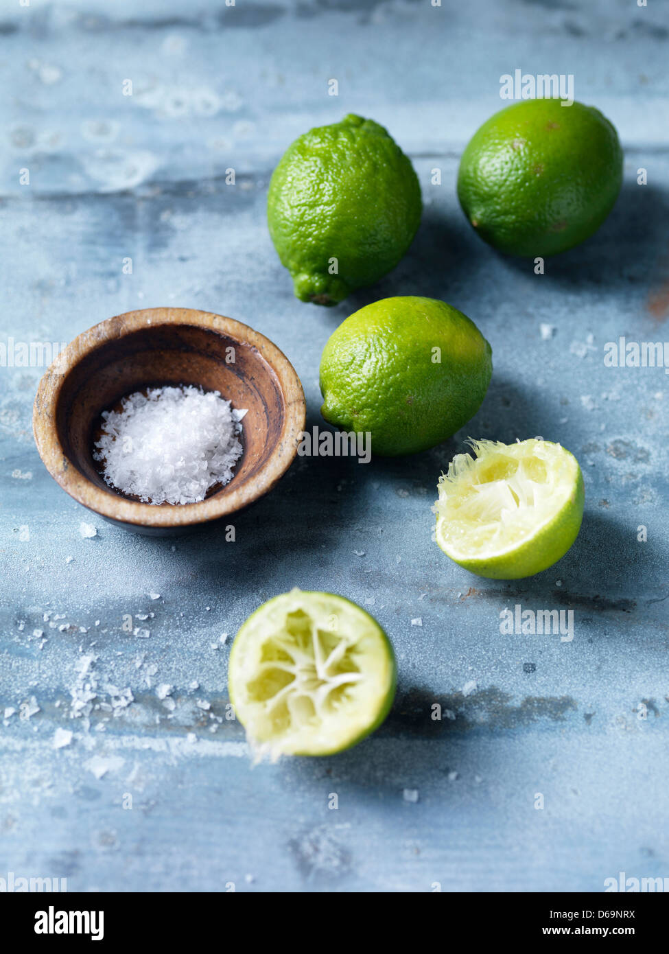 Limes with salt on zinc table Stock Photo - Alamy