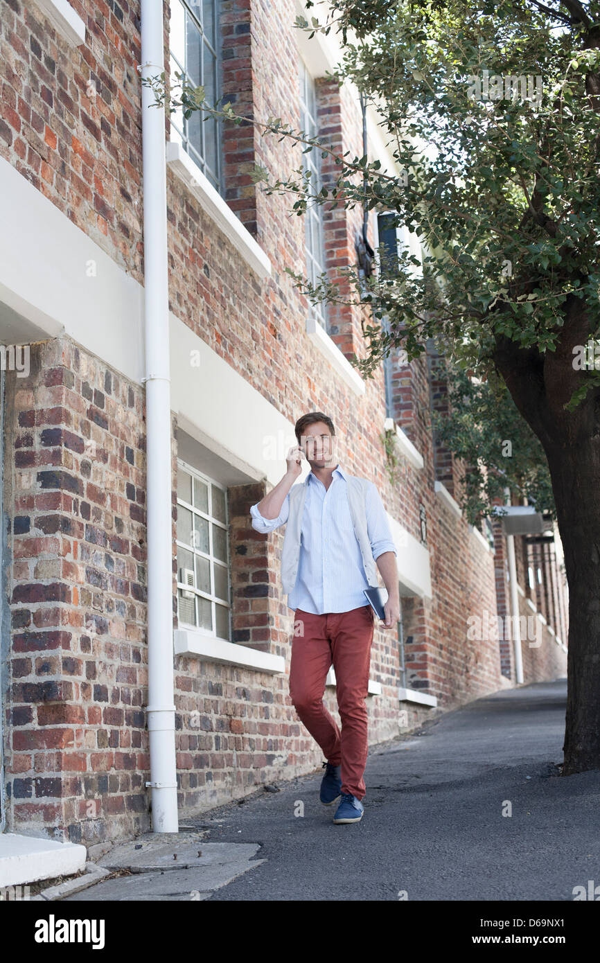 Man talking on cell phone on city street Stock Photo - Alamy