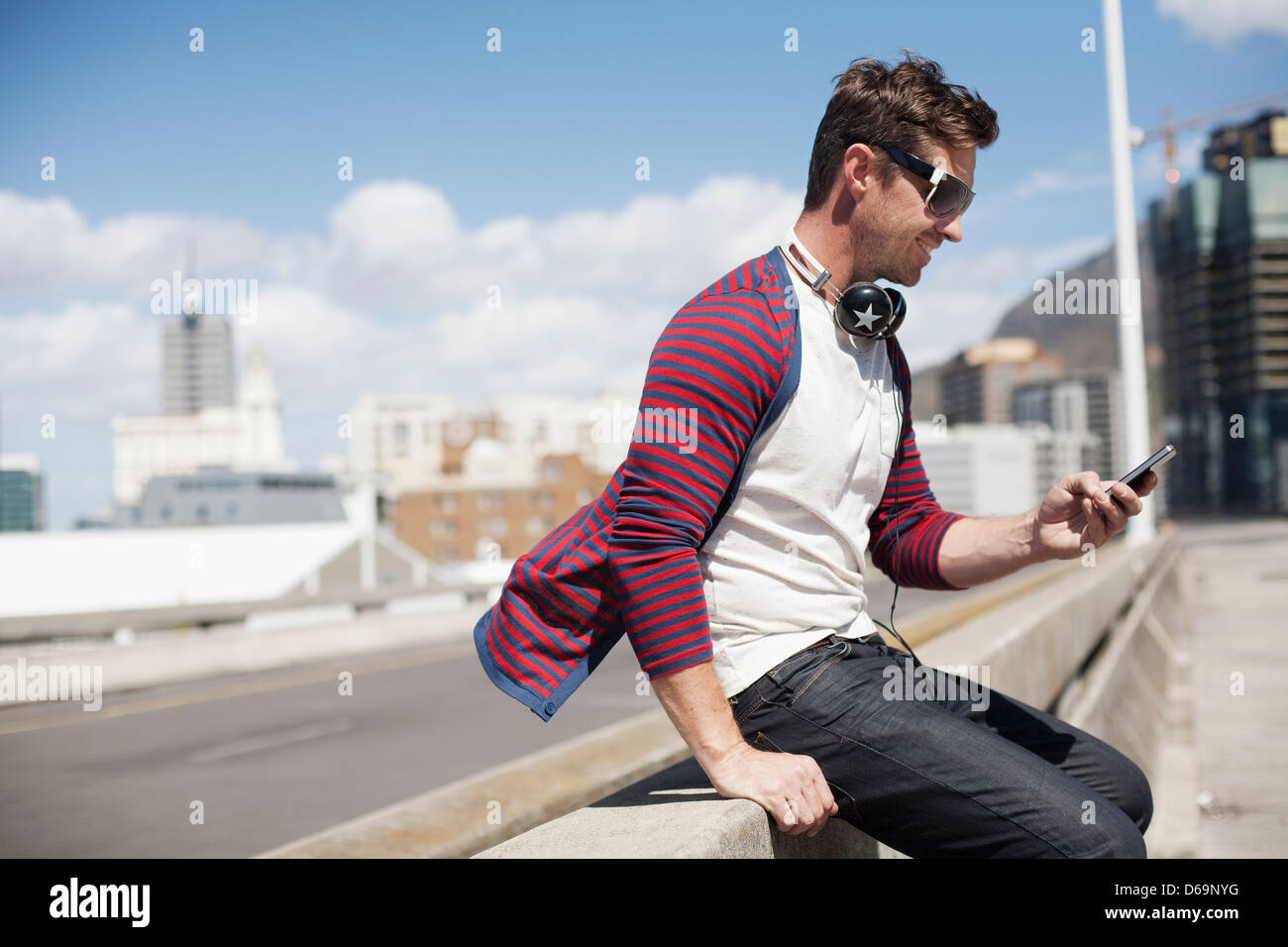 Man using cell phone on city street Stock Photo - Alamy