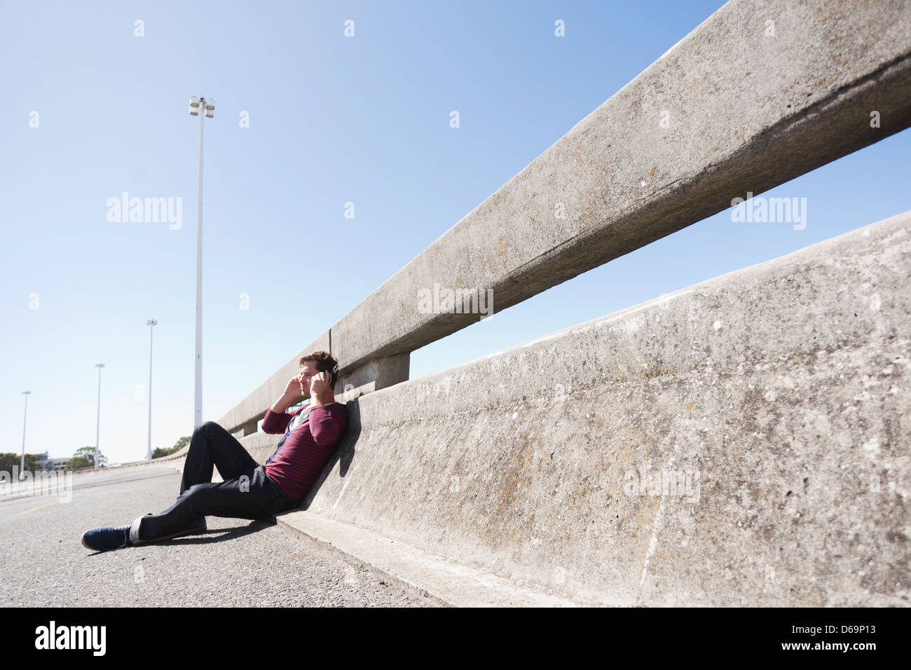 Man wearing headphones on city street Stock Photo - Alamy
