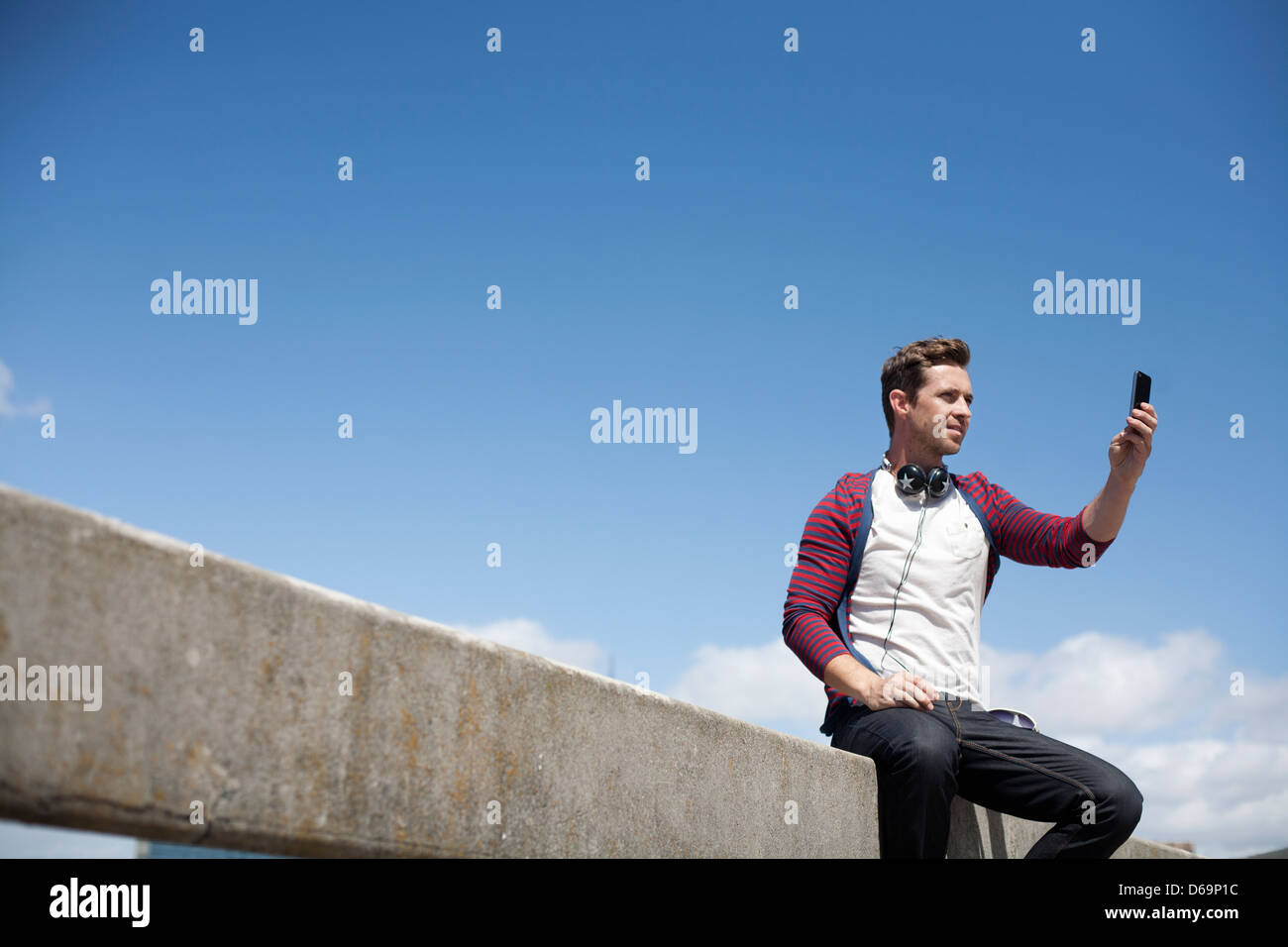 Man using cell phone on city street Stock Photo - Alamy