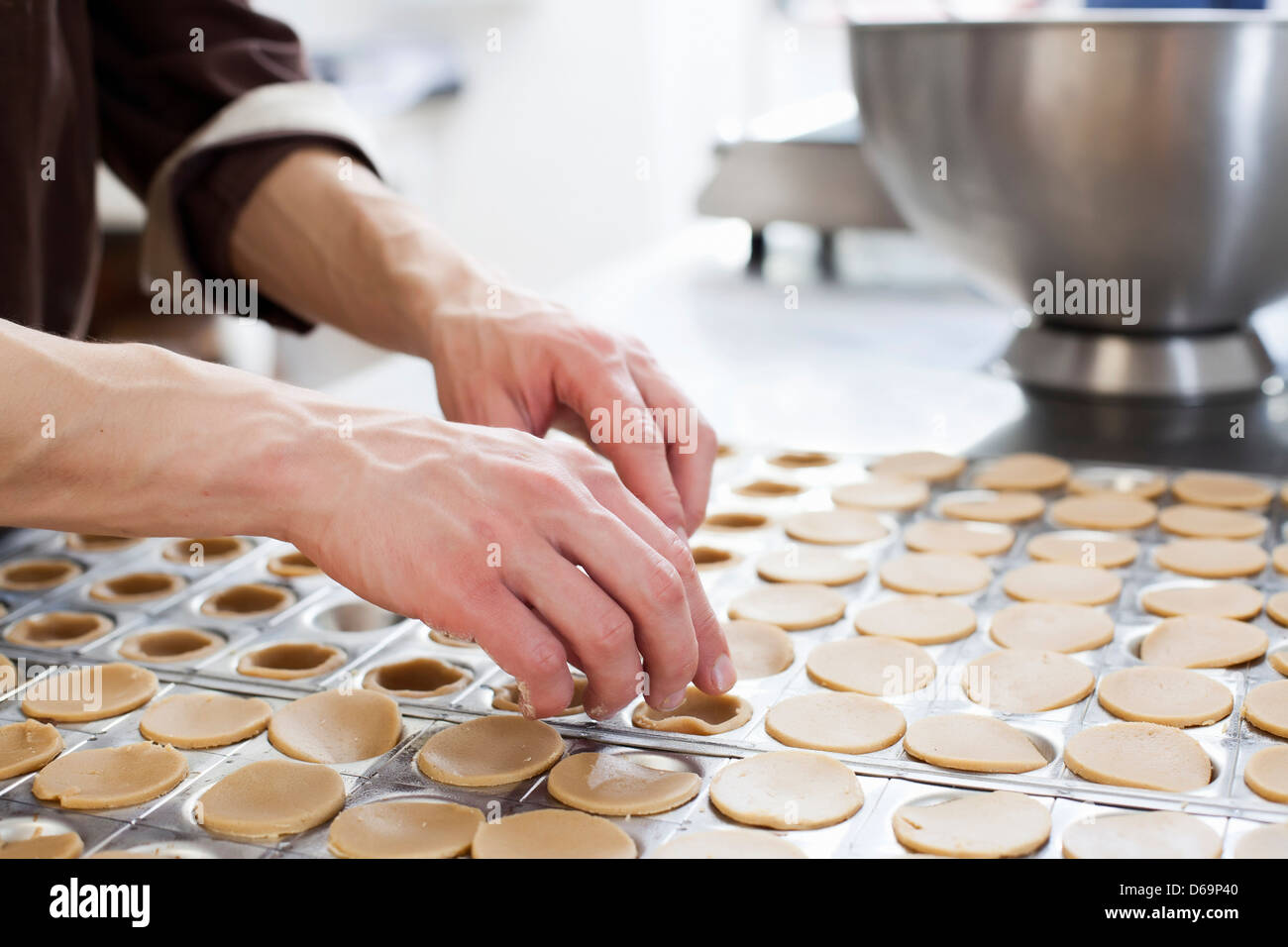 Baker shaping pastry in kitchen Stock Photo - Alamy