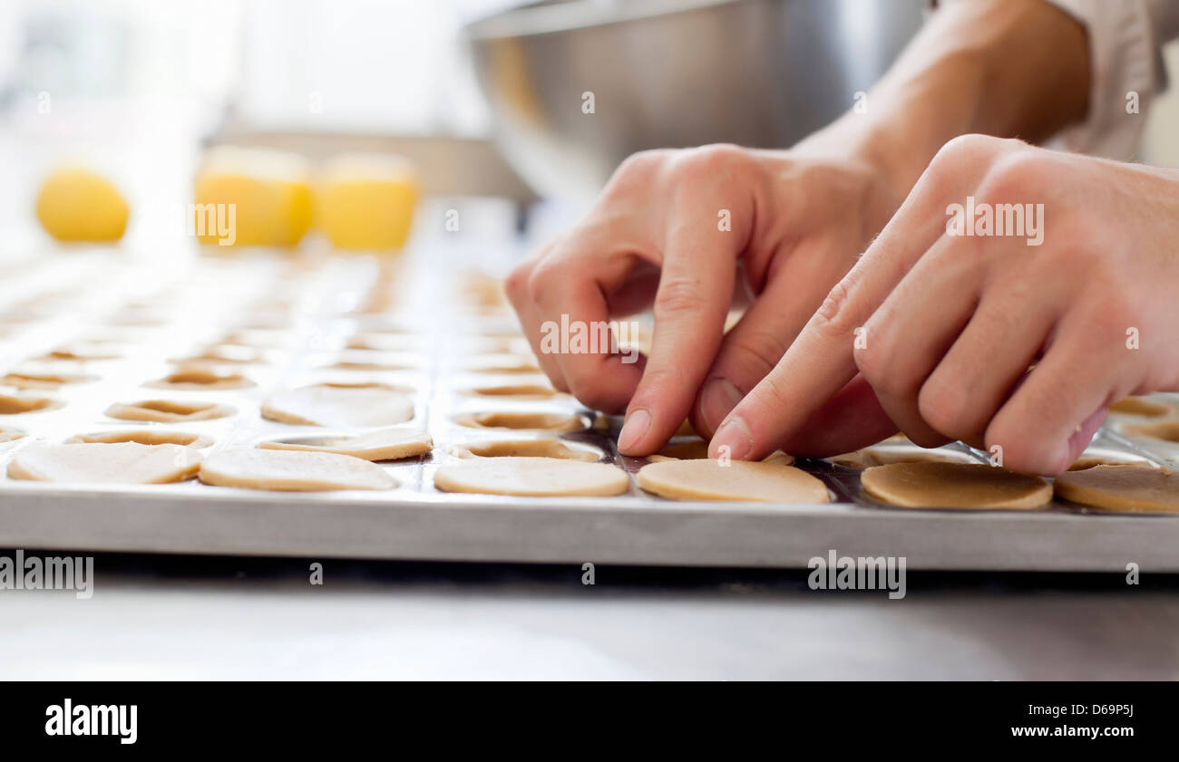 Baker shaping pastry in kitchen Stock Photo - Alamy