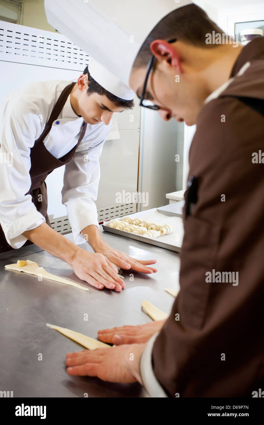 Bakers shaping dough in kitchen Stock Photo - Alamy