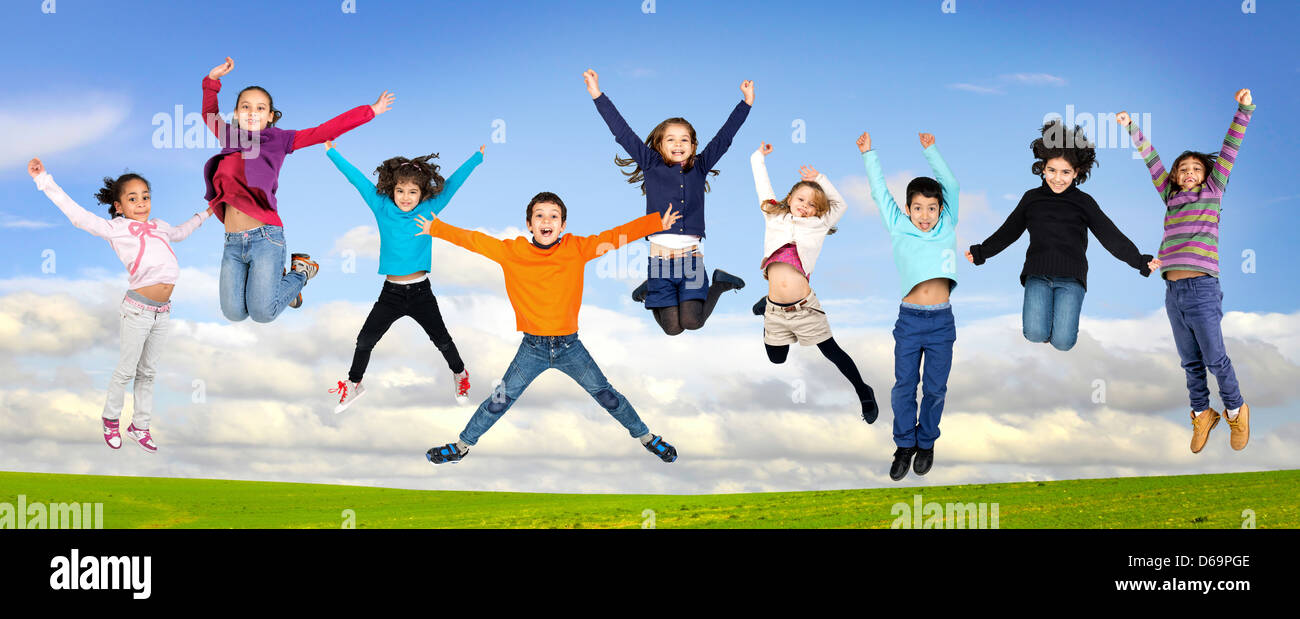 Group of children jumping outdoors Stock Photo - Alamy