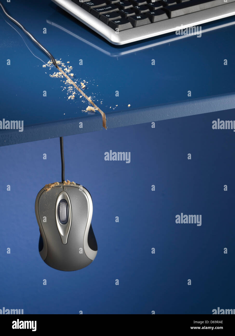 Computer mouse hanging from desk Stock Photo - Alamy
