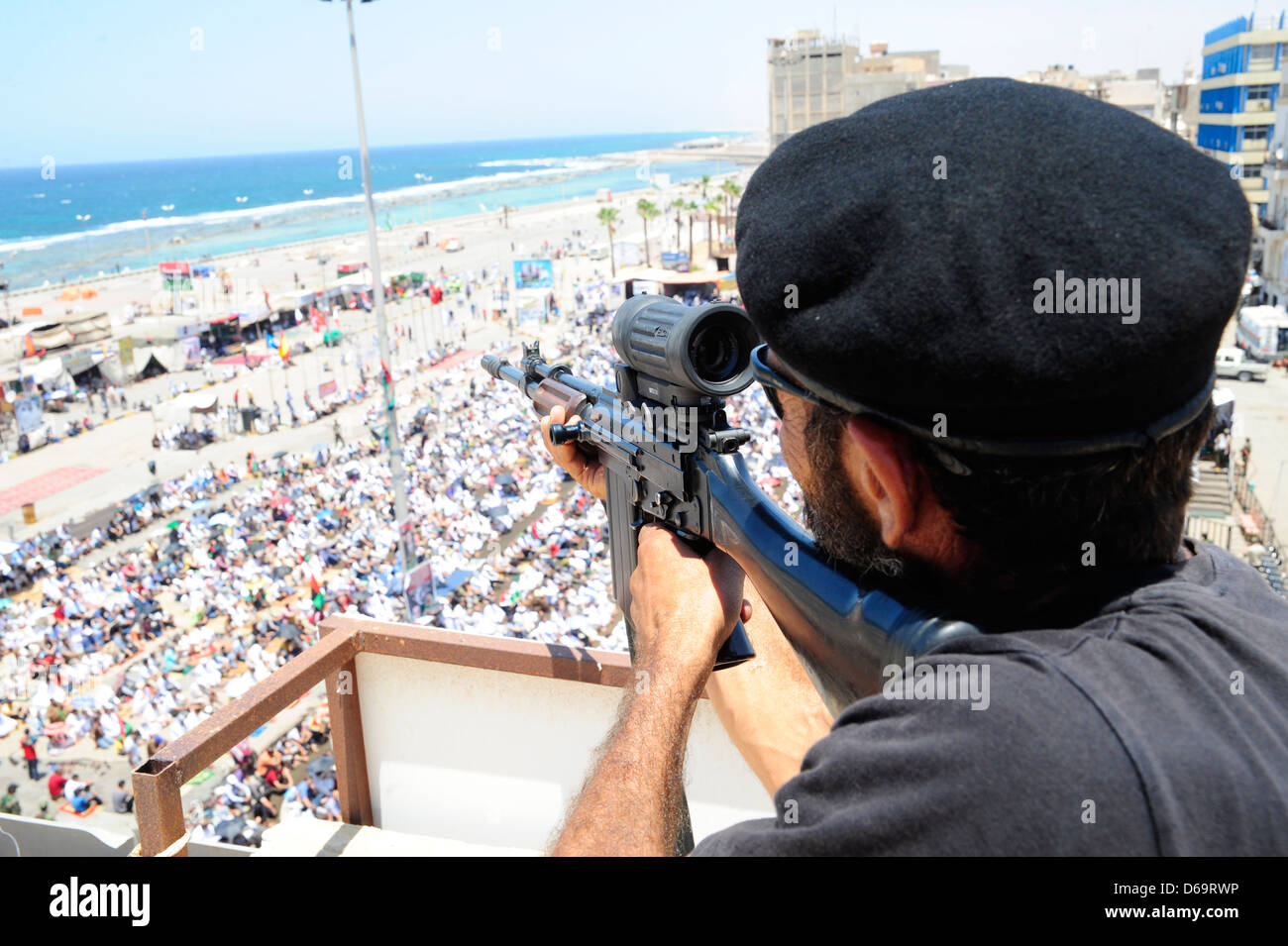 A NLA sniper on the rooftop overlooking the square in Benghazi during ...