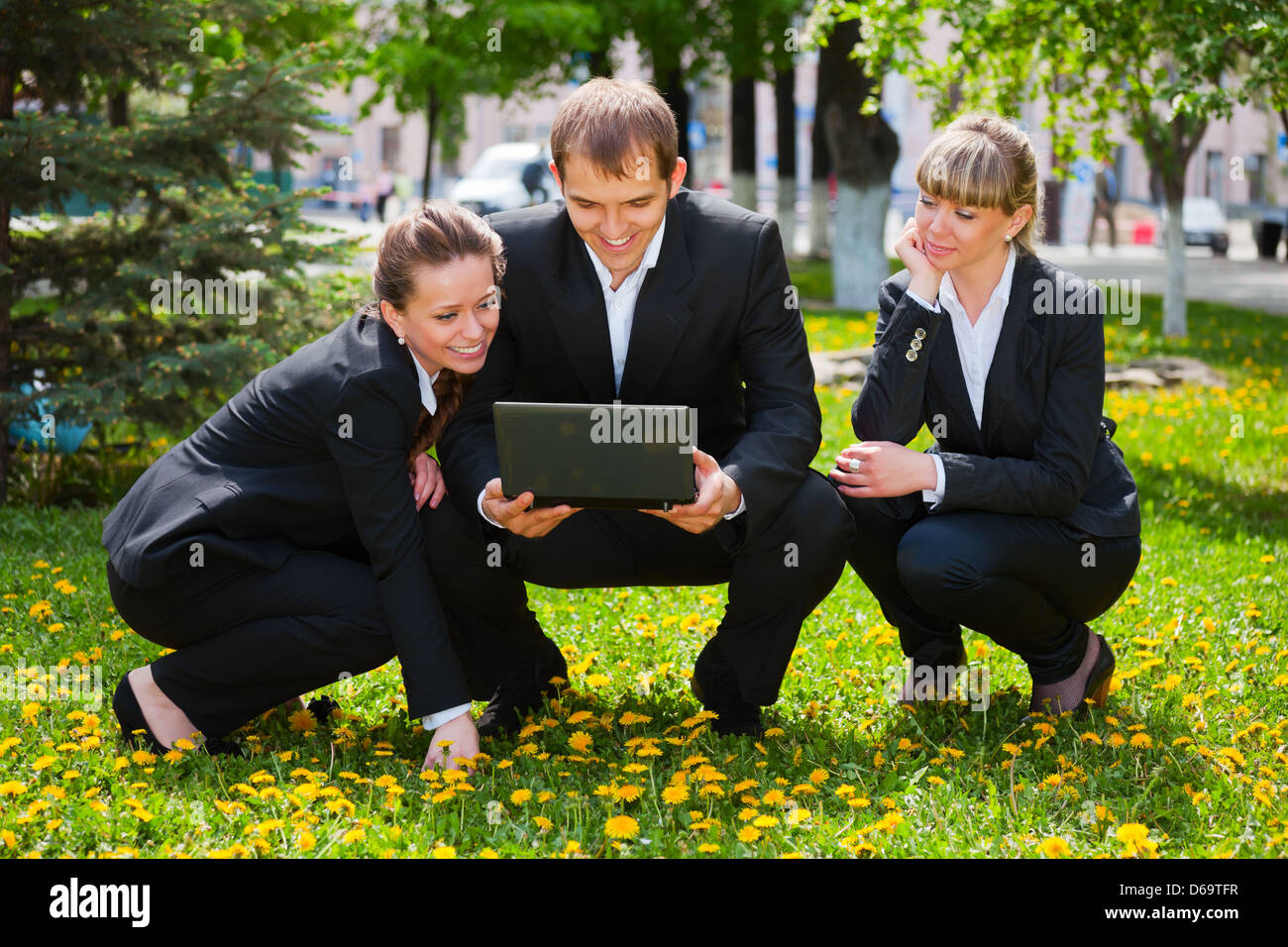 Young business people with laptop Stock Photo - Alamy