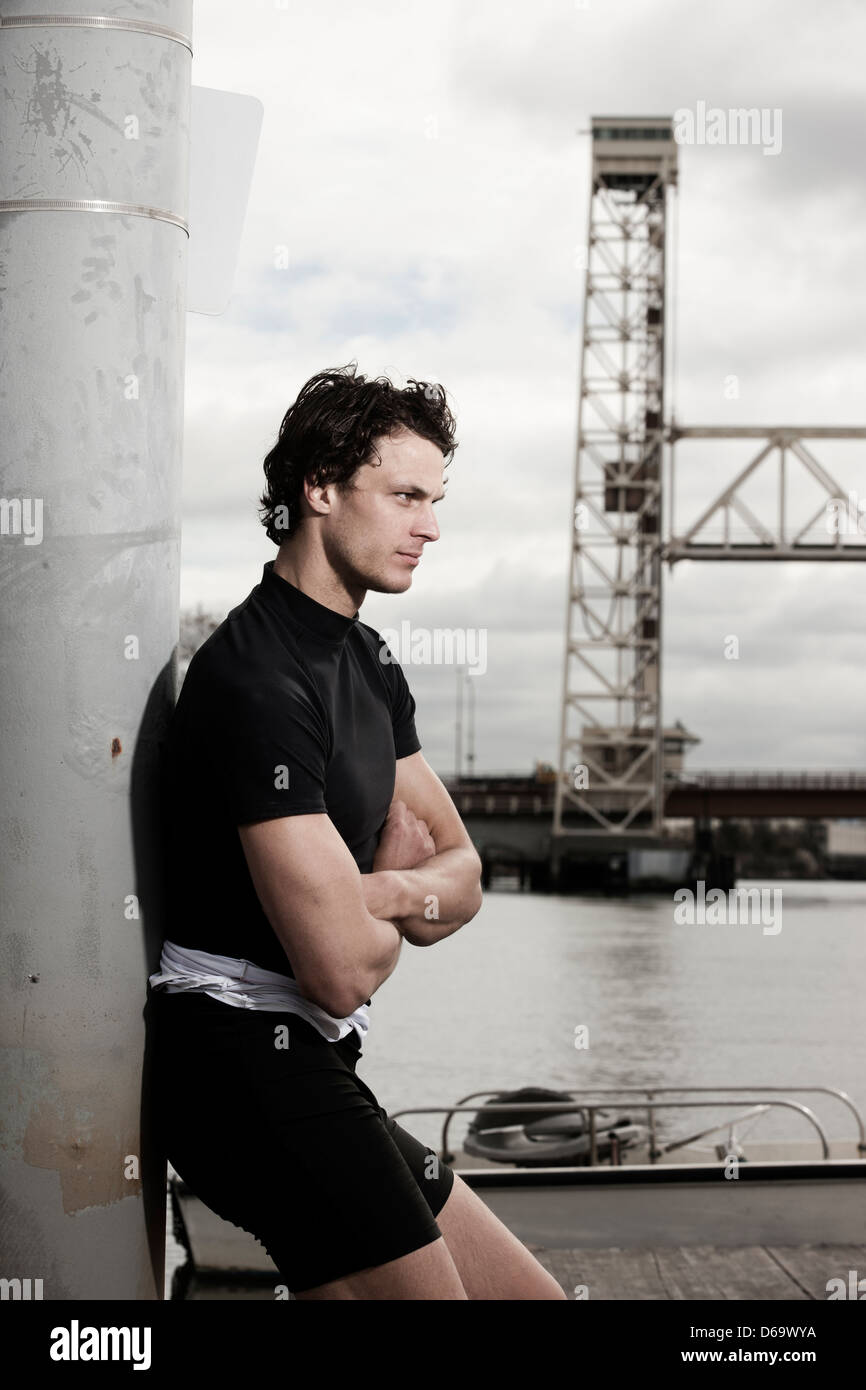 Runner standing on urban waterfront Stock Photo - Alamy
