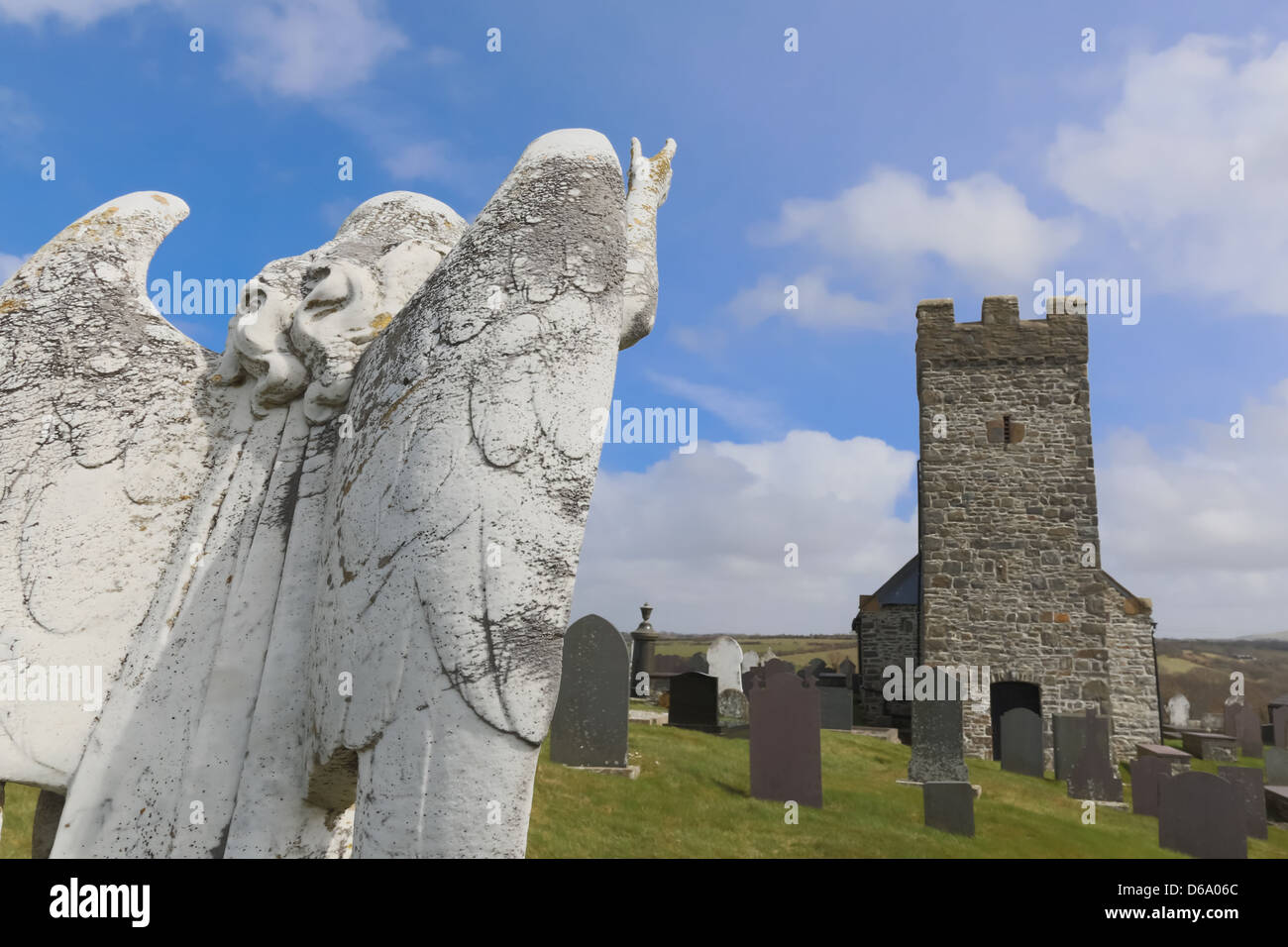 White stone angel memorial and church tower Stock Photo - Alamy