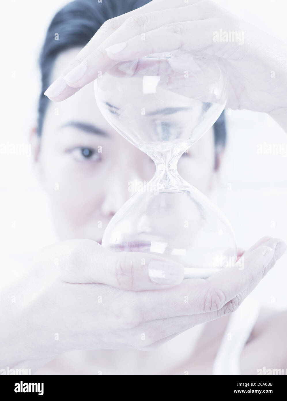 Woman holding hourglass Stock Photo - Alamy