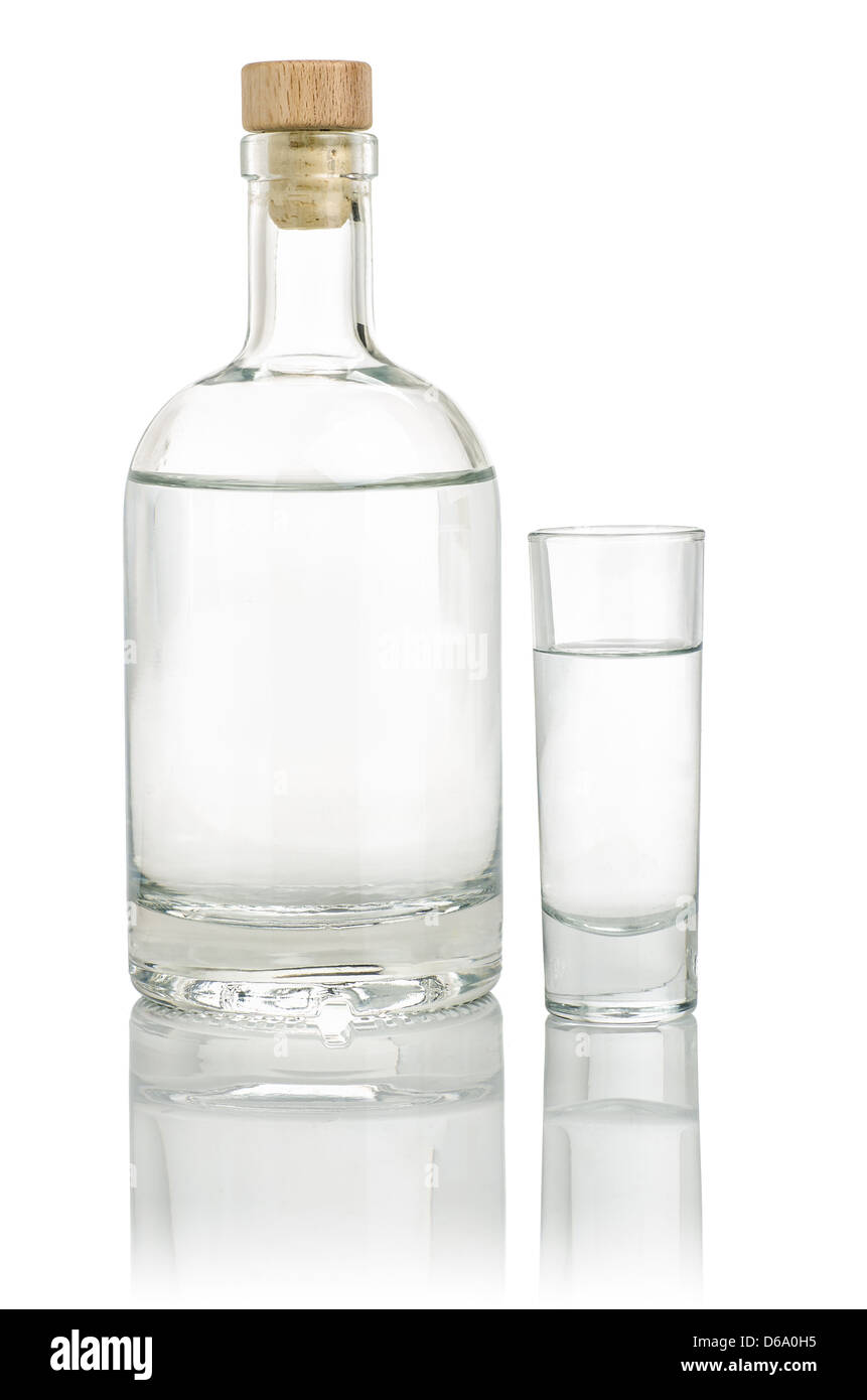 Liquor bottle with a full shot glass Stock Photo - Alamy