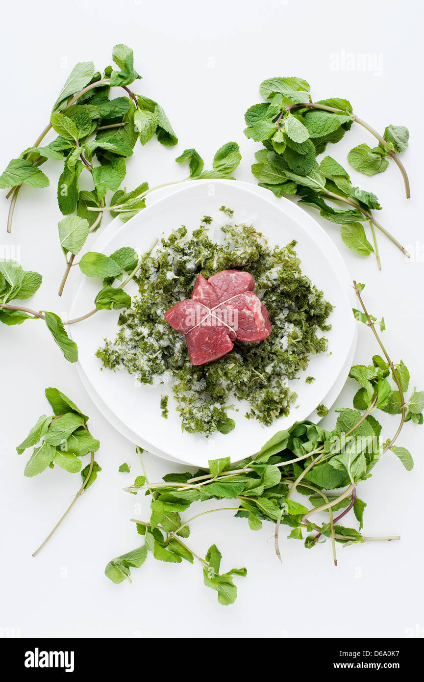 Plate of meat with herbs Stock Photo - Alamy