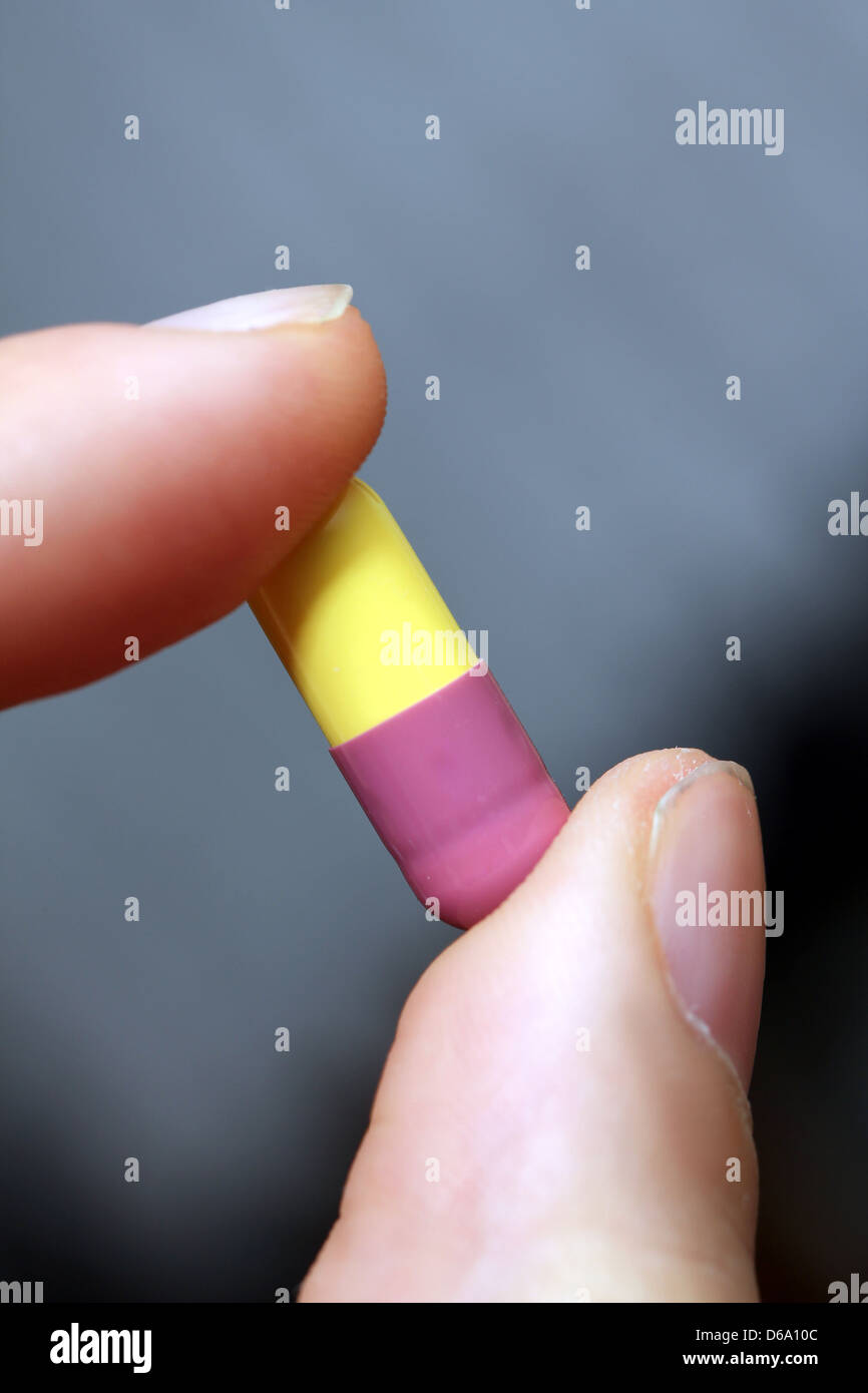 the capsule in hands Stock Photo - Alamy