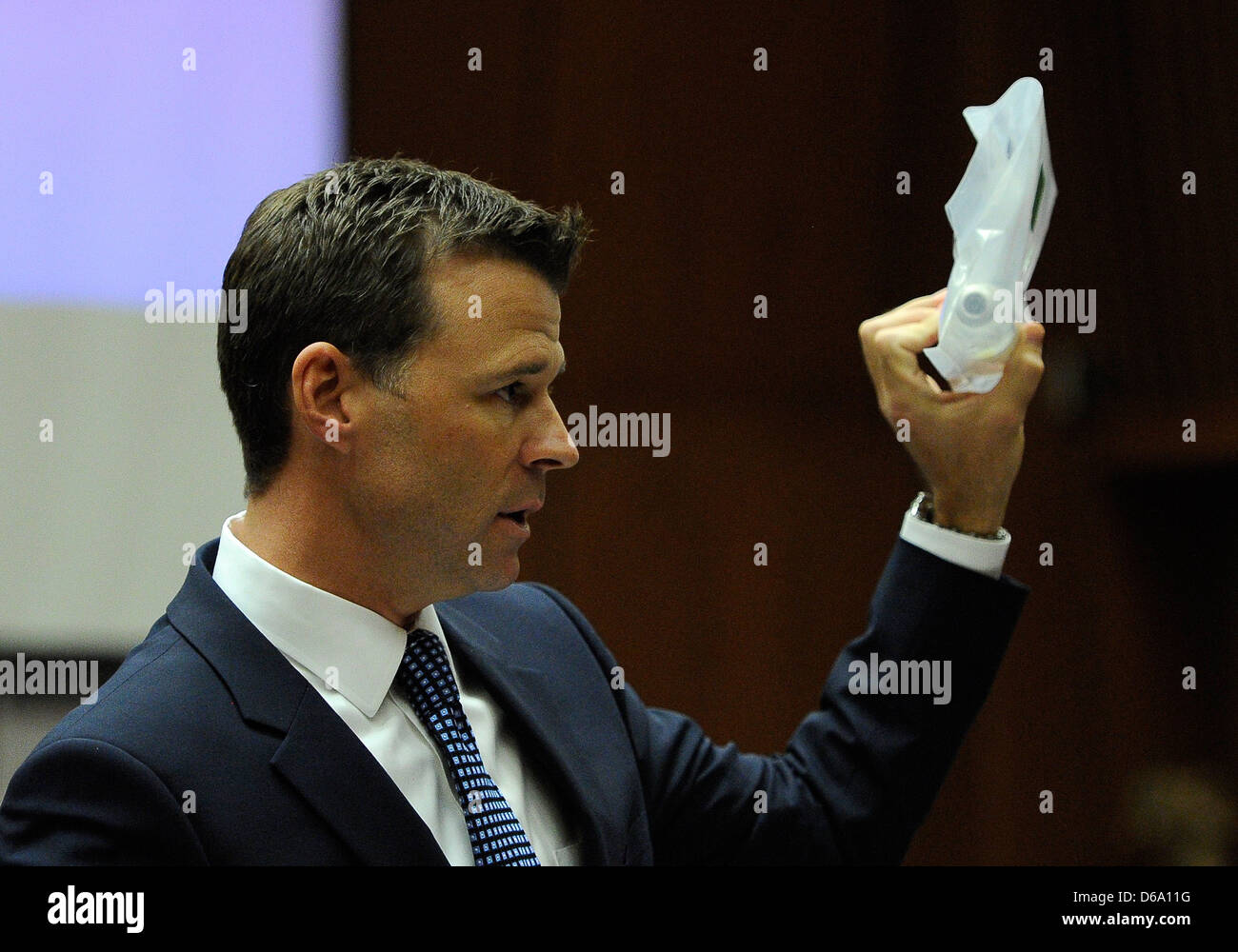 Los Angeles Deputy District Attorney David Walgren holds up evidence ...