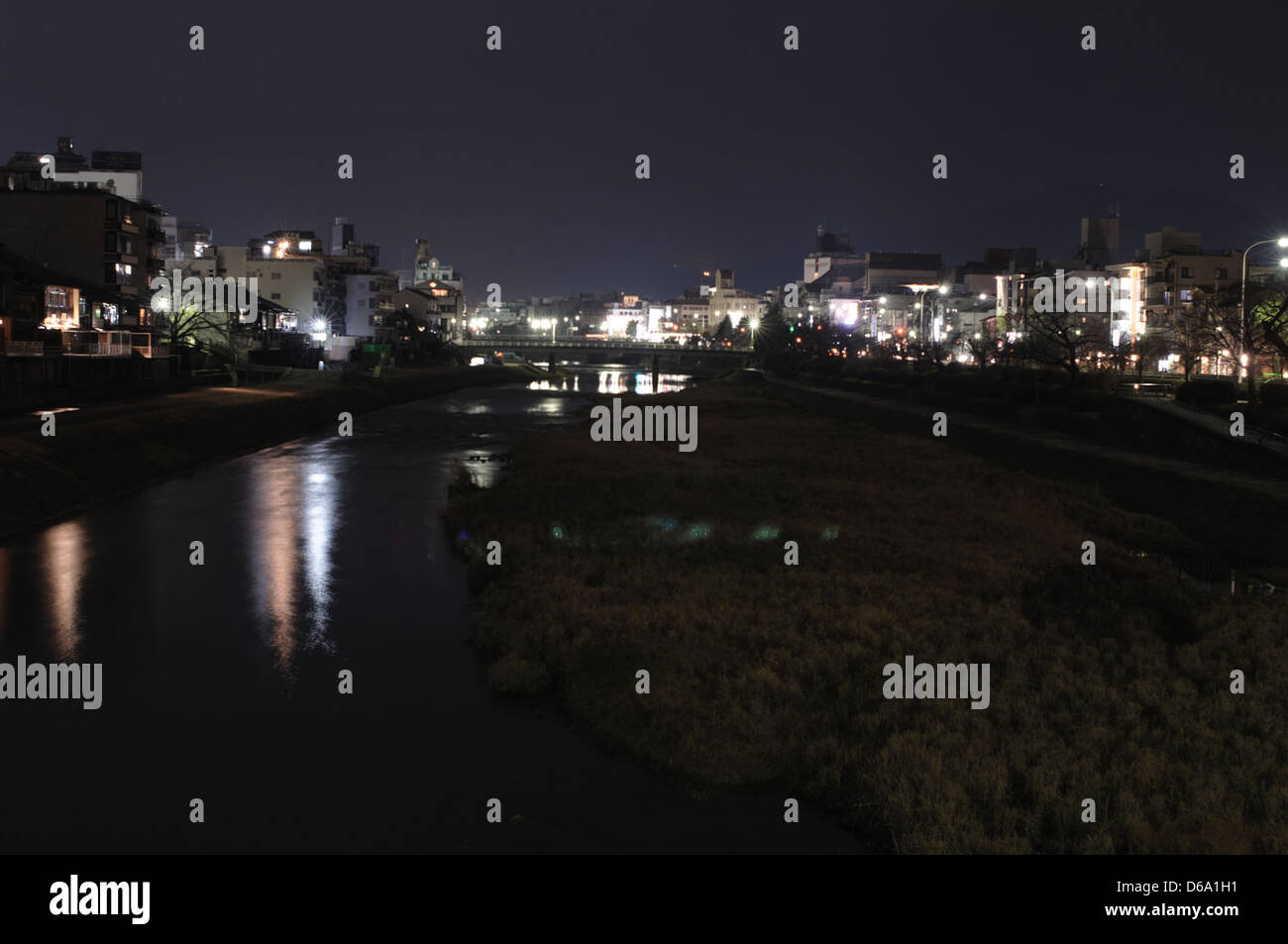 A nighttime photo of the Kamogawa River in Kyoto, Japan, showing the ...