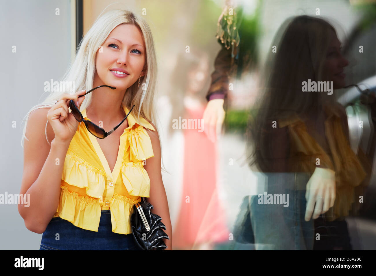 Young woman against a shop window Stock Photo - Alamy