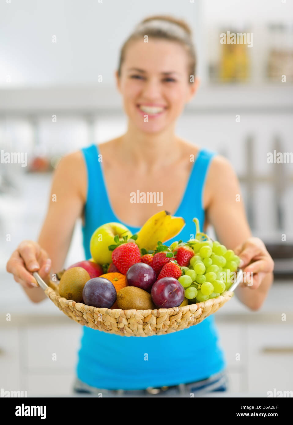 Closeup on plate of fresh fruits giving by smiling young woman Stock ...