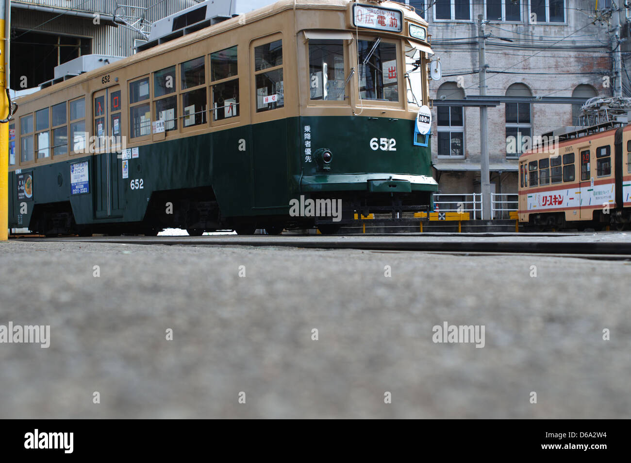 The Hiroshima Hiroden 650 series streetcar, operating at Hirodenhonshamae Station in Hiroshima ...