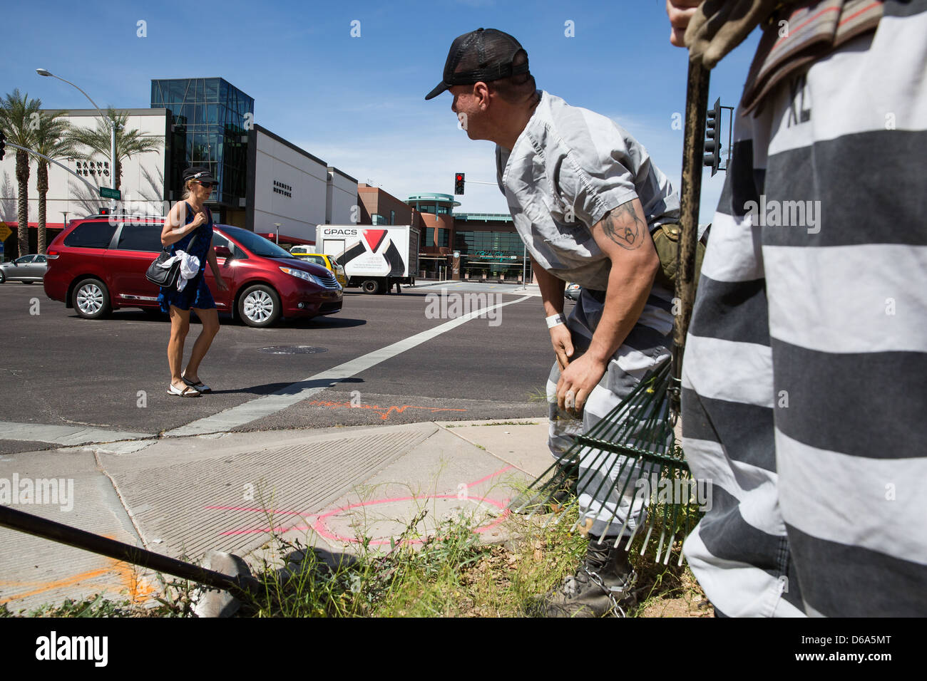 A male inmate checks out a woman crossing the street in a wealthy area ...
