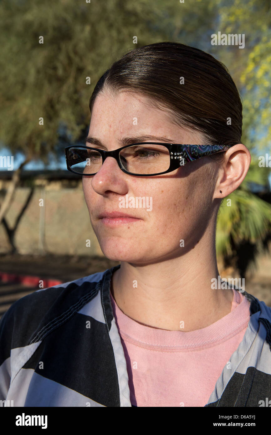 A female inmate waits in line at dawn Stock Photo - Alamy