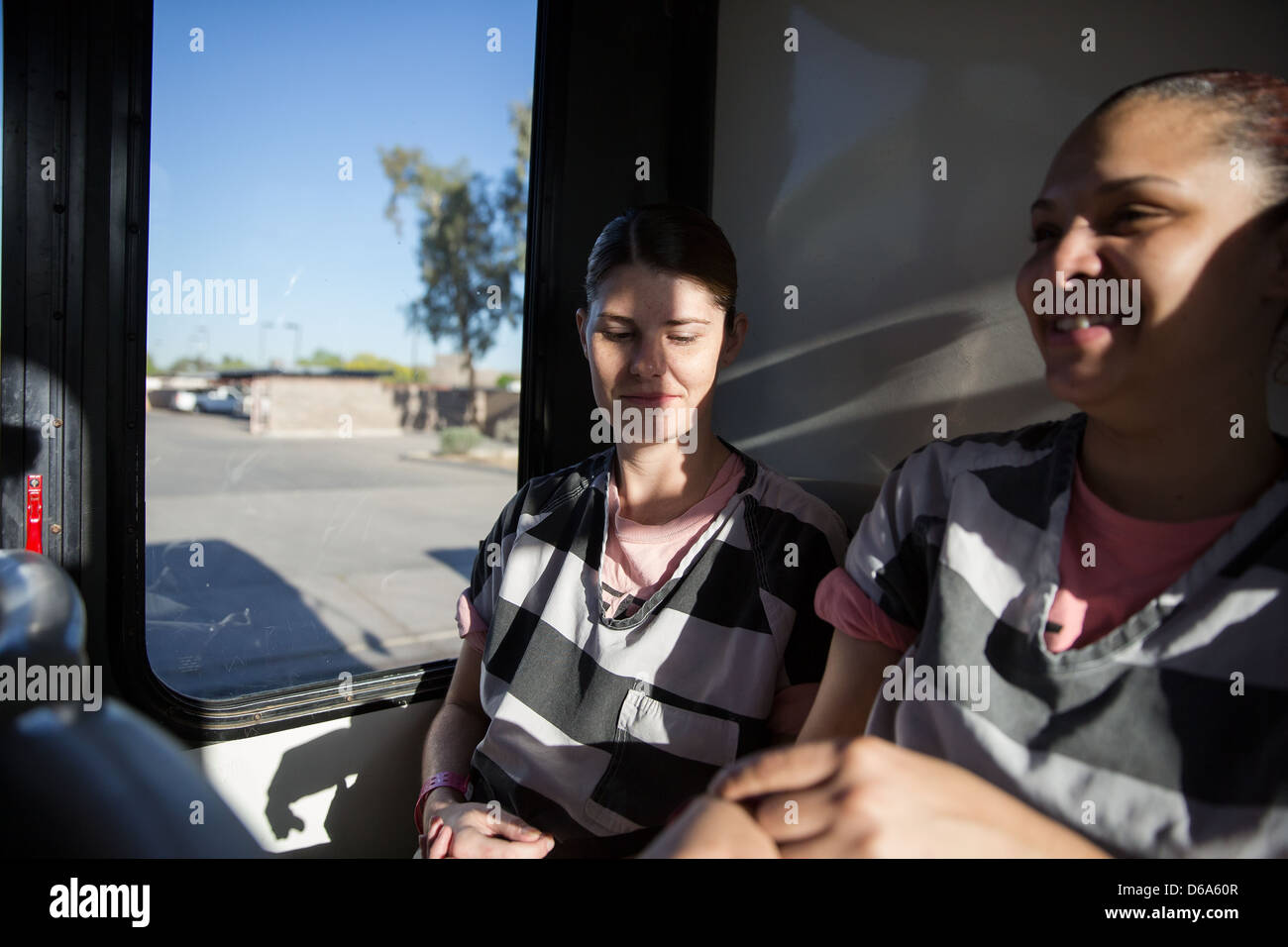 Female inmates on the bus at dawn Stock Photo - Alamy