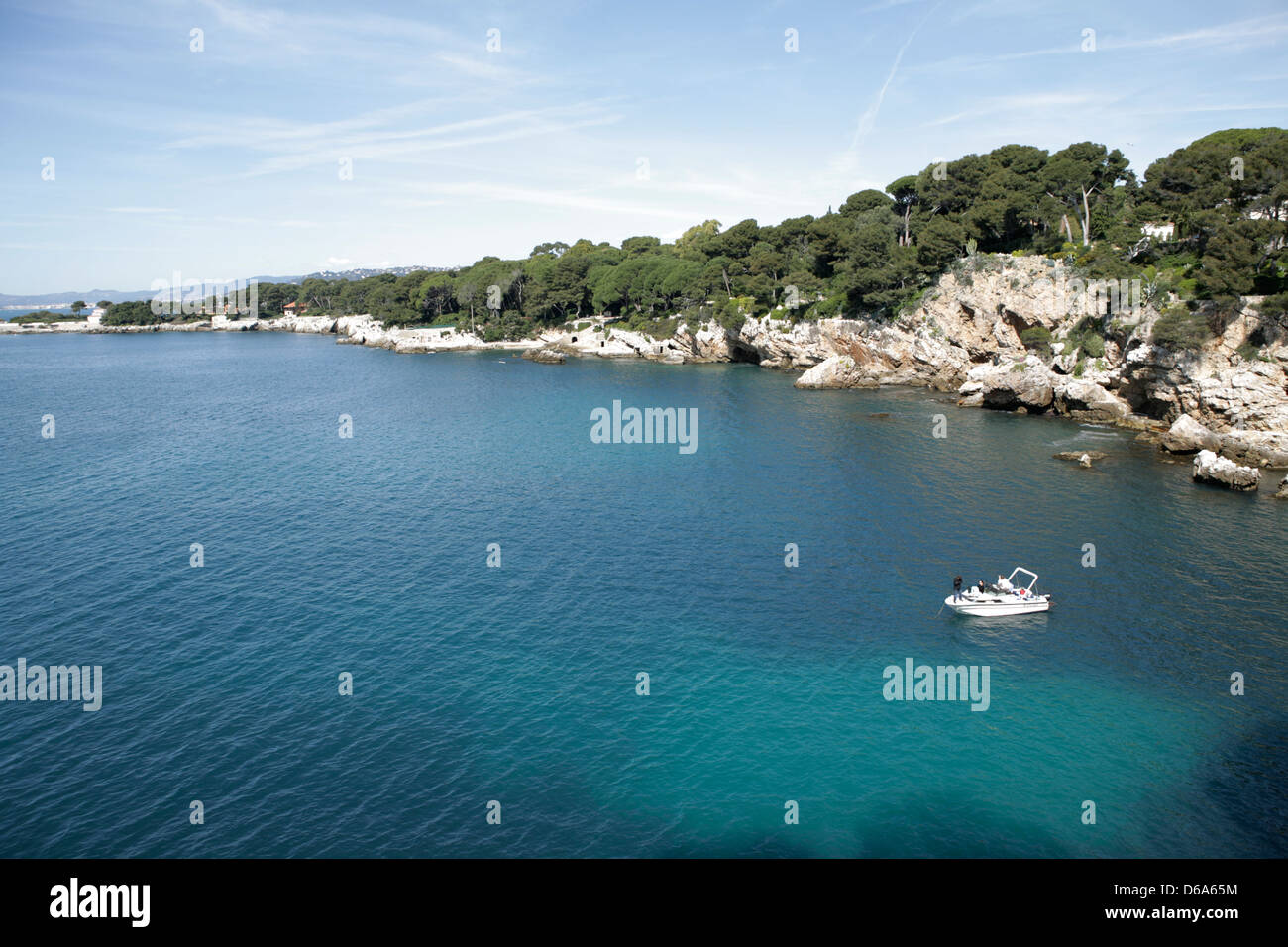 Small power boat in a secluded bay in the Mediterranean sea off Antibes ...
