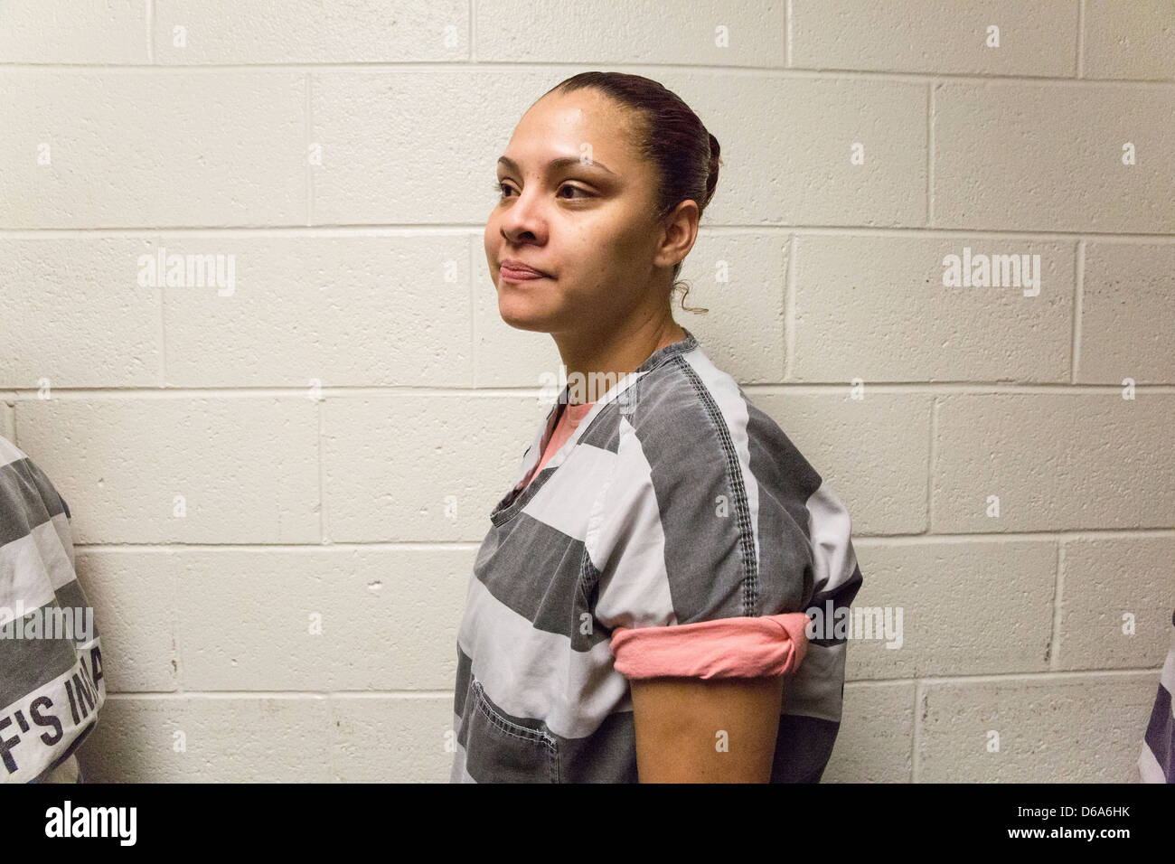 An inmate of the female chain gang waits in line before going on chain ...