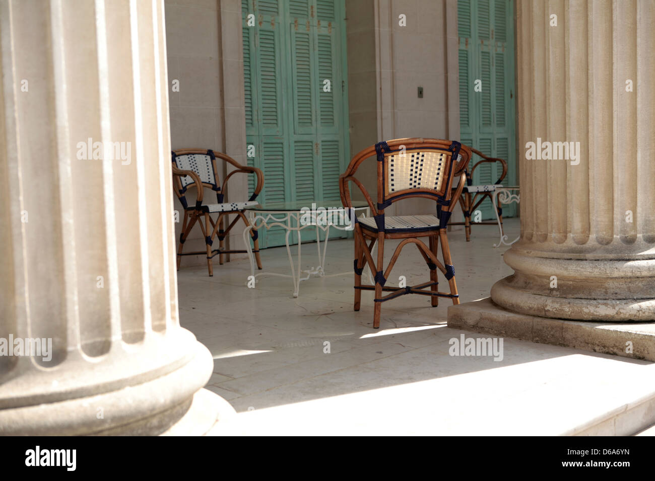 Chairs and classic Ionic Columns in shade Stock Photo - Alamy