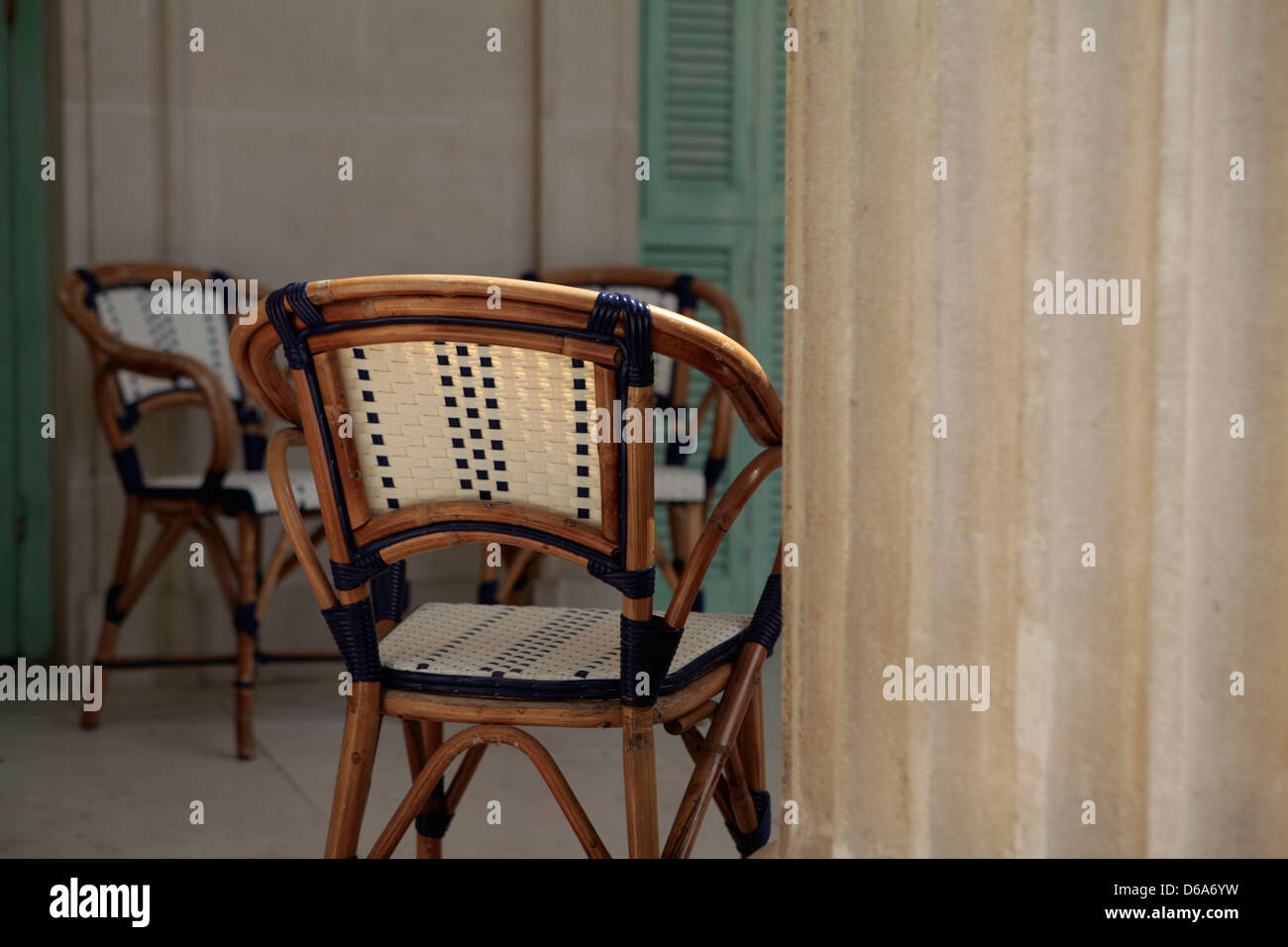 Chairs and classic Ionic Columns in shade Stock Photo - Alamy