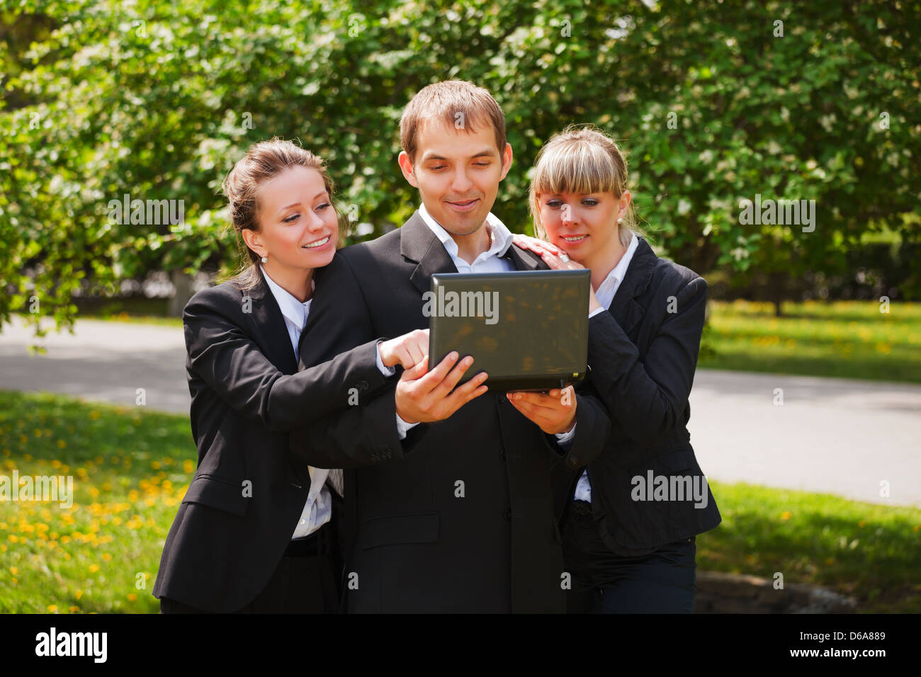 Young business people with laptop Stock Photo - Alamy