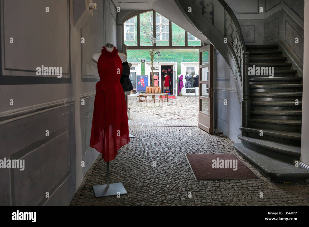 Entrance to an inner courtyard lined with trendy fashion shops in ...