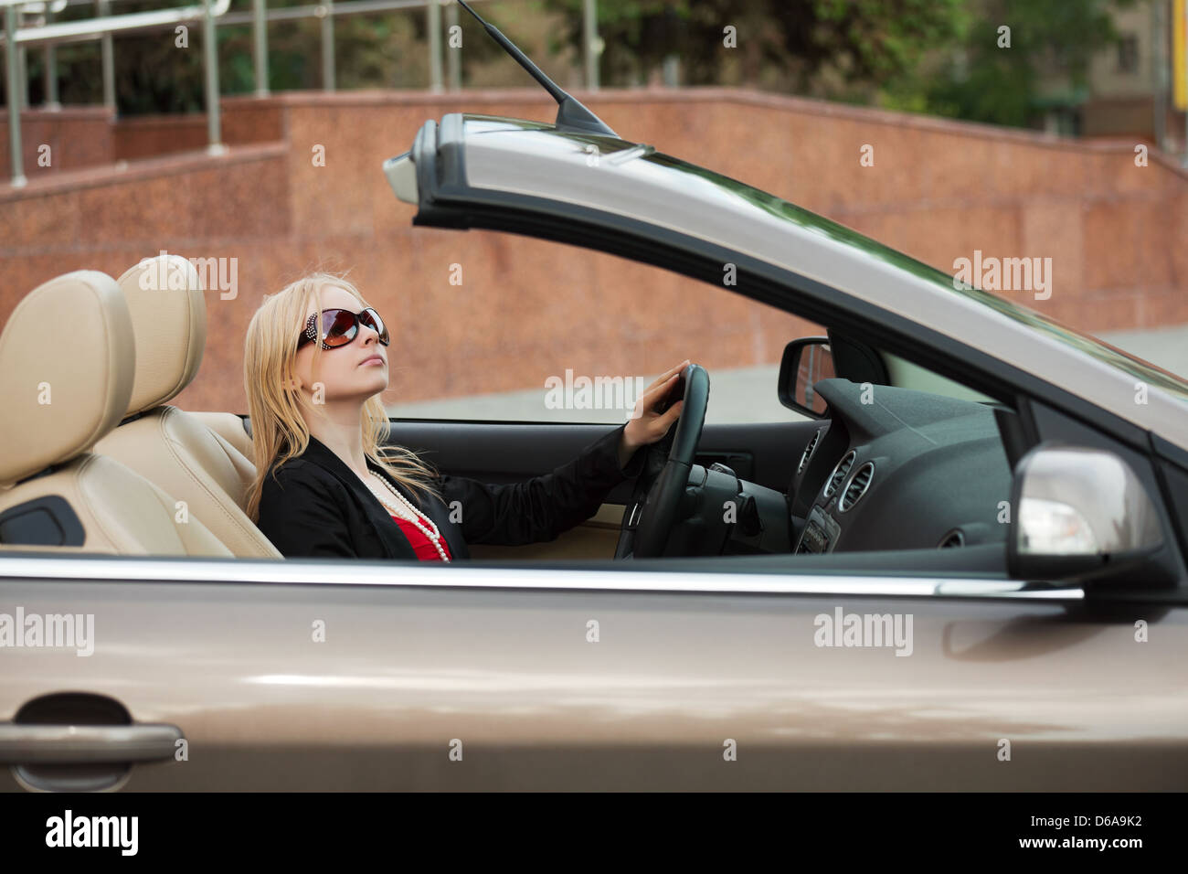Young woman driving a convertible car Stock Photo - Alamy