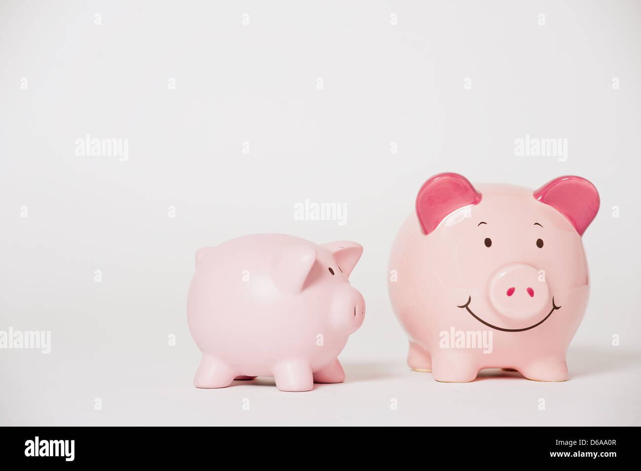 Two piggy banks one white one pink hi-res stock photography and images ...