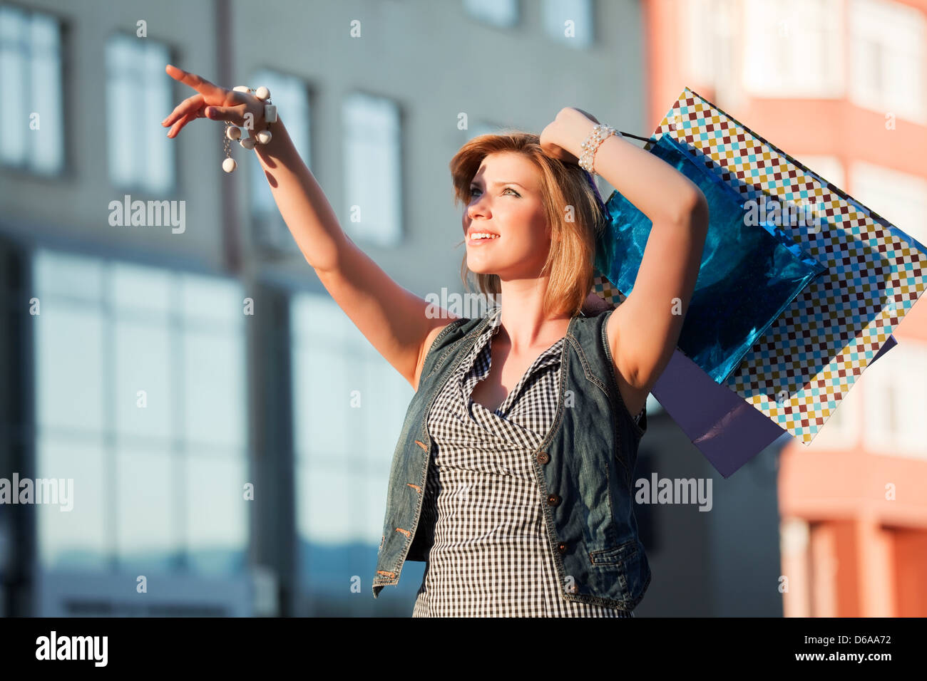Happy shopper on a city street Stock Photo - Alamy