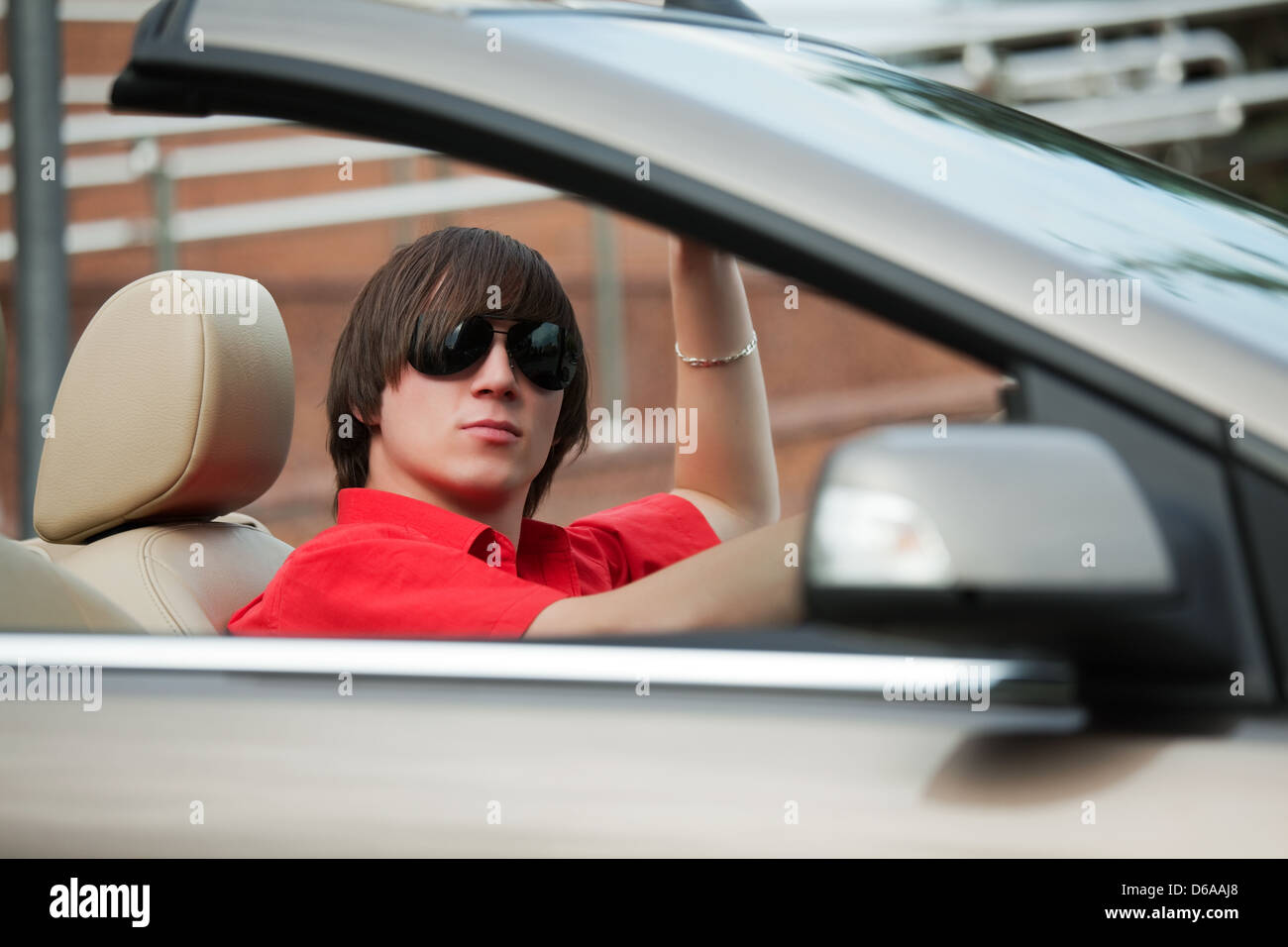 Young man driving a convertible car Stock Photo - Alamy